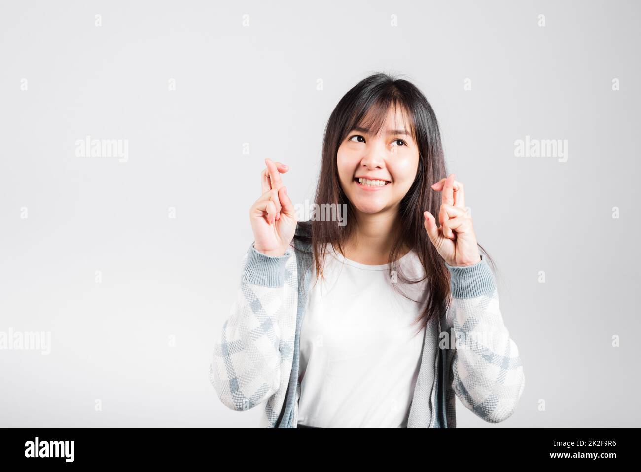 Happy woman have superstition her holding fingers crossed for good luck ...