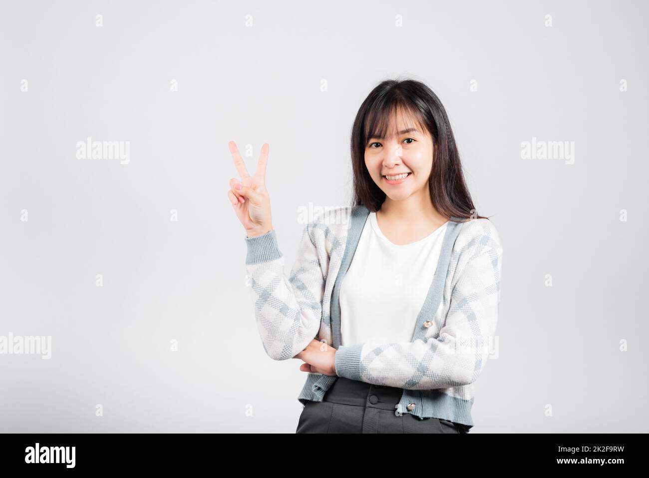 Woman showing finger making v-sign victory symbol side away looking to ...