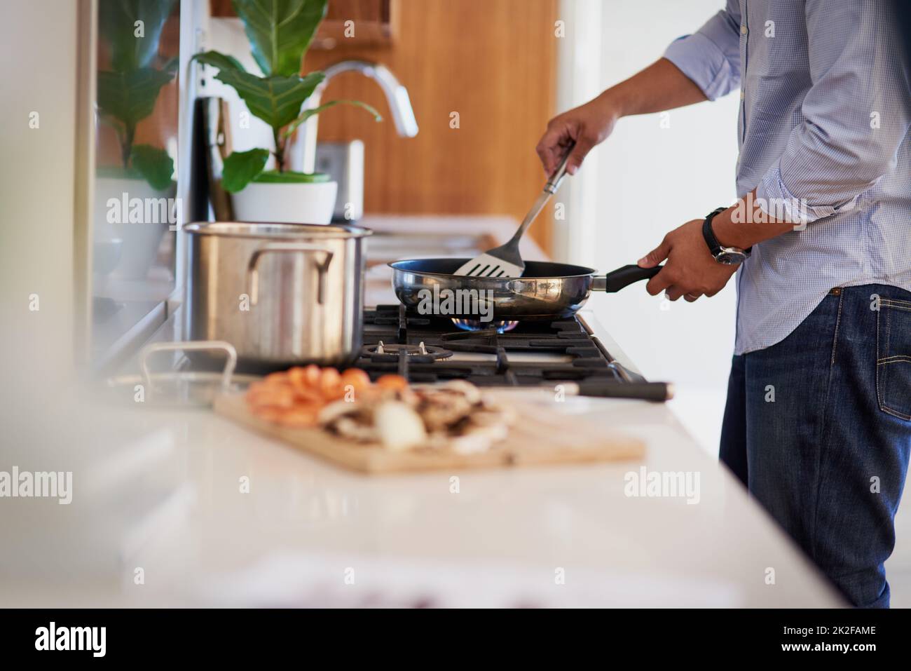 Cooking up something delicious. Shot of an unrecognizable man cooking ...
