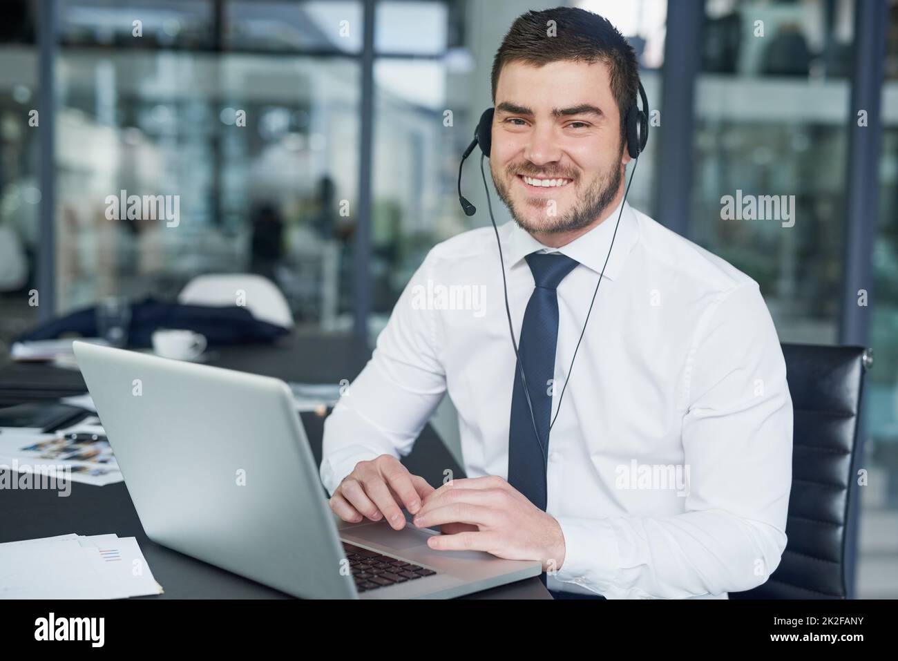 Happy to be or assistance. Portrait of a young customer service ...