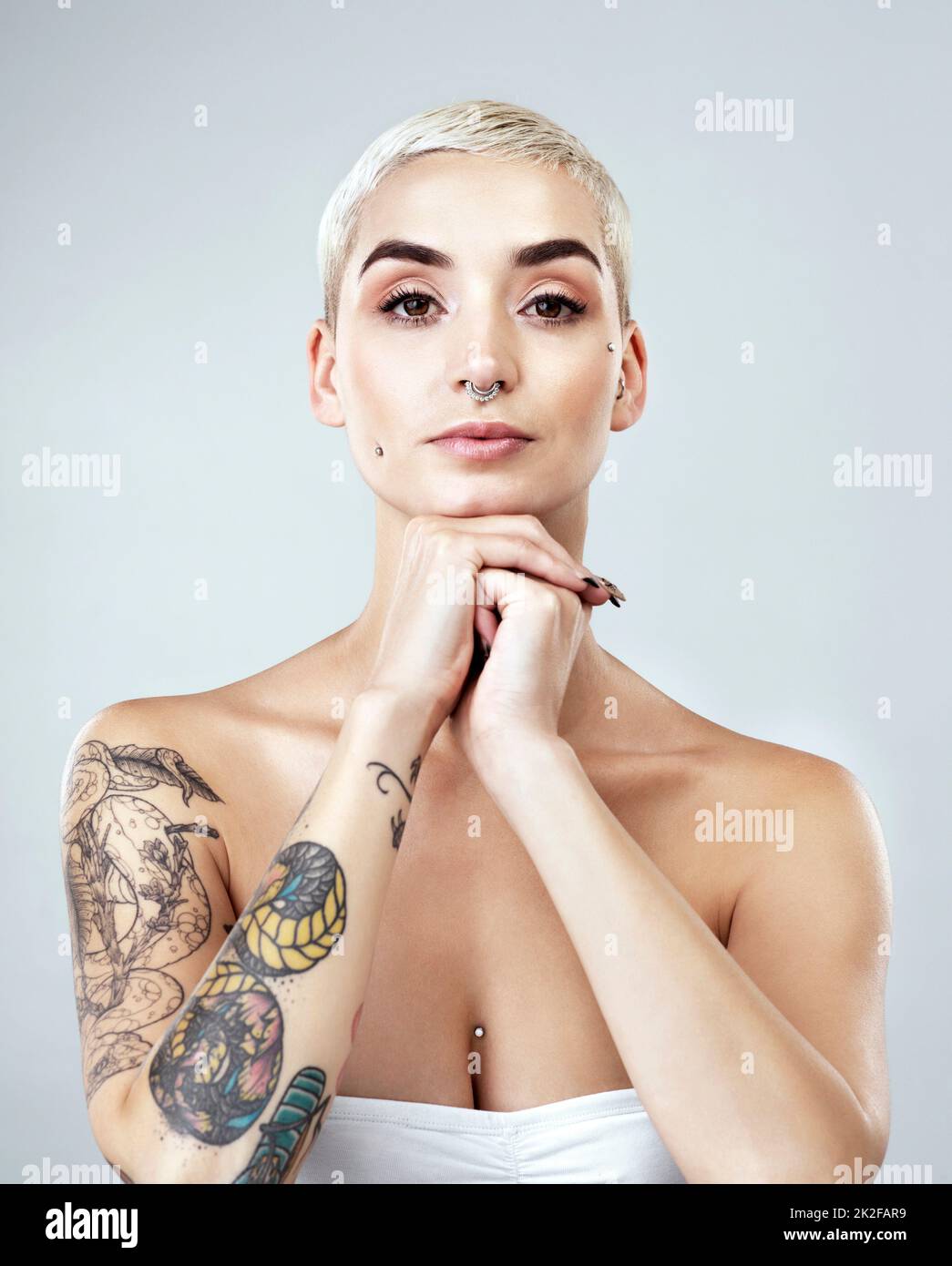 She has beauty and confidence. Studio portrait of a beautiful young woman posing against a grey ...