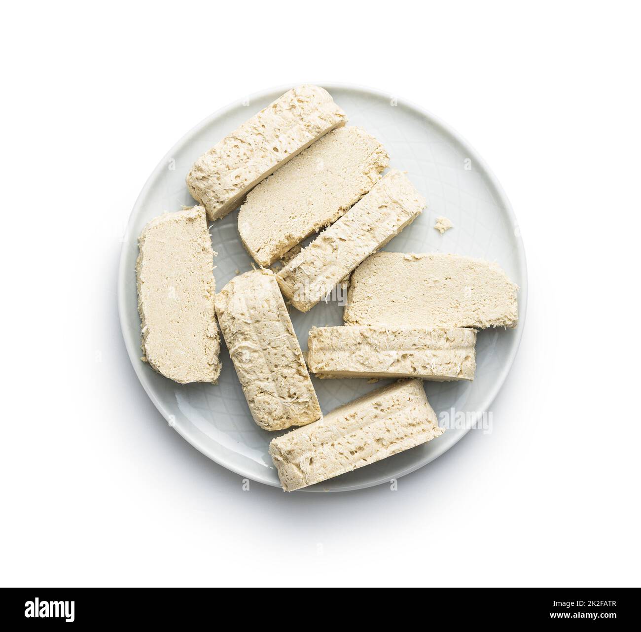 Sweet tahini halva on plate. Turkish dessert isolated on white ...