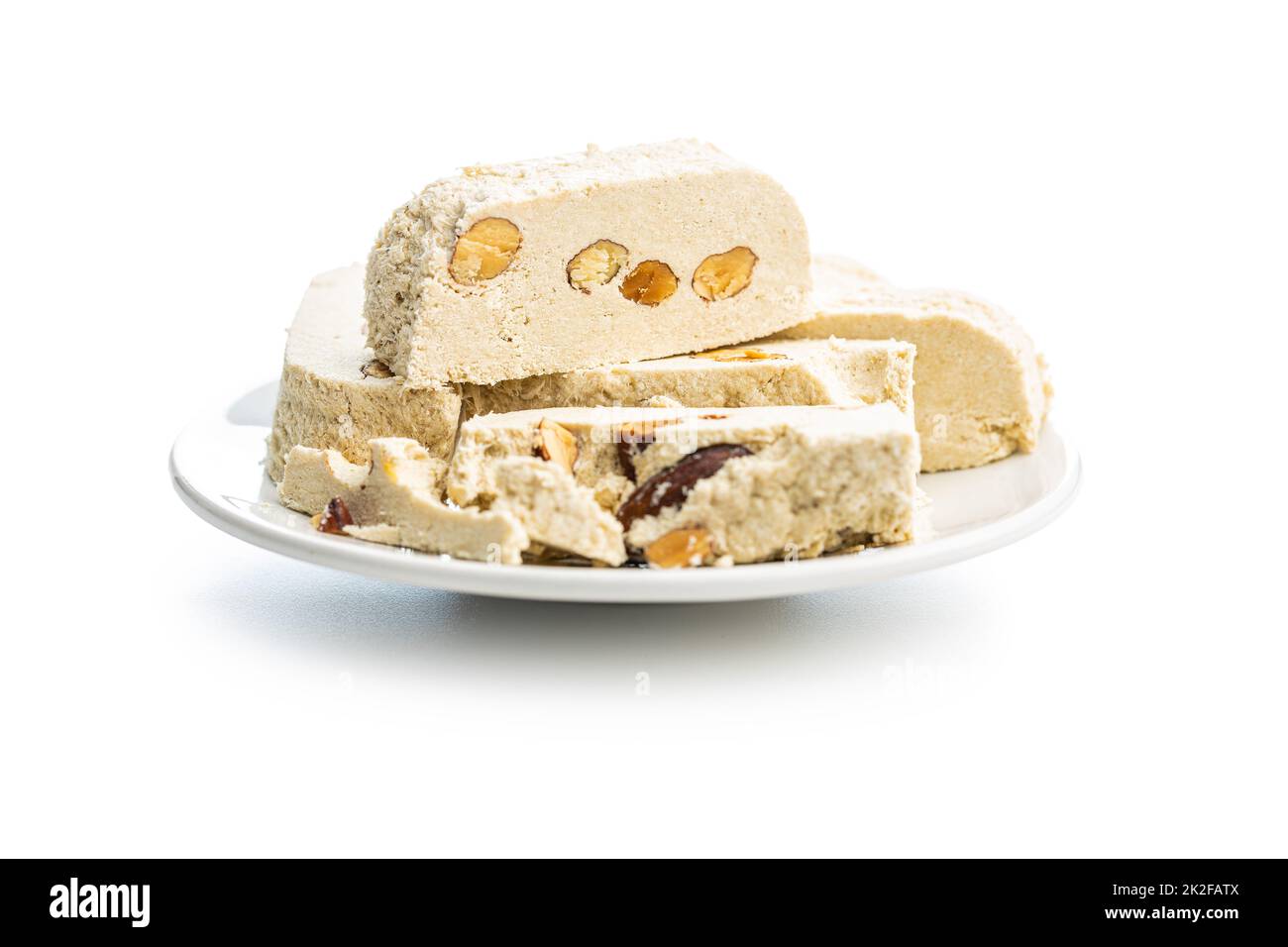 Sweet tahini halva with almonds. Turkish dessert isolated on white background Stock Photo - Alamy