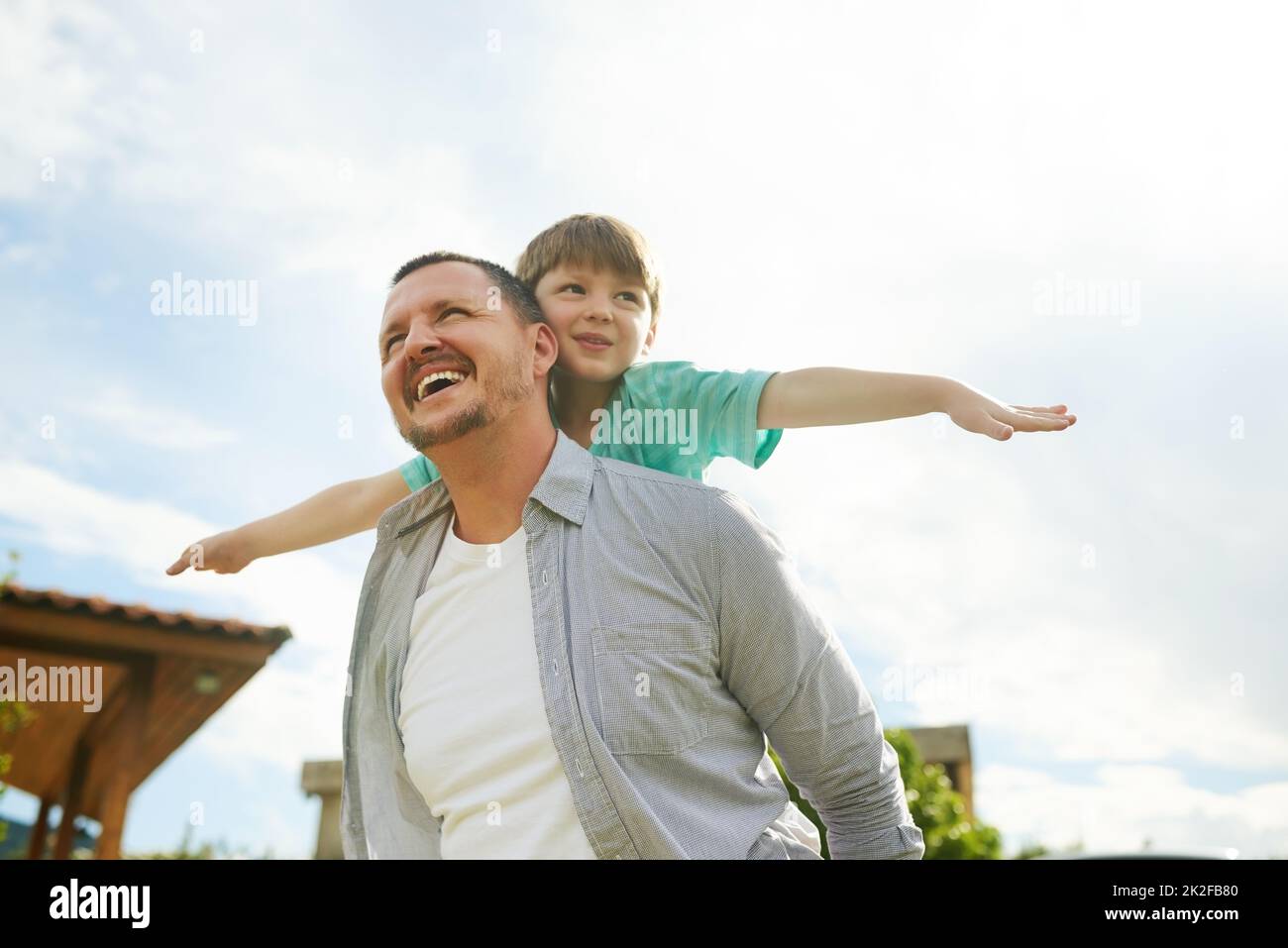 Dad will always be your wings to lift you up. Cropped shot of a young handsome father giving his ...