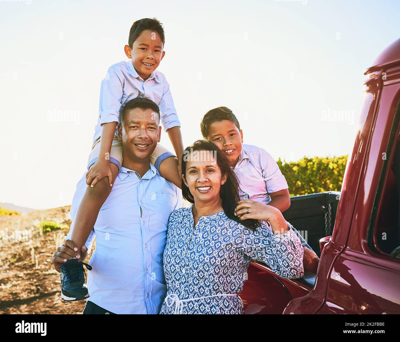 On a road trip with the family. Shot of a cheerful family posing for a ...
