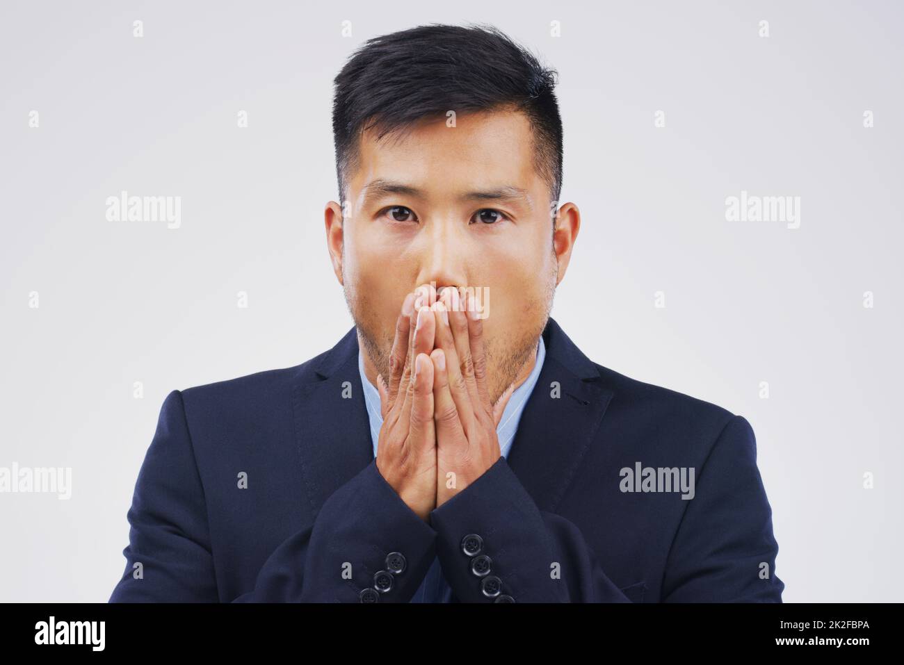 I messed up big time. Studio shot of a young man looking shocked ...
