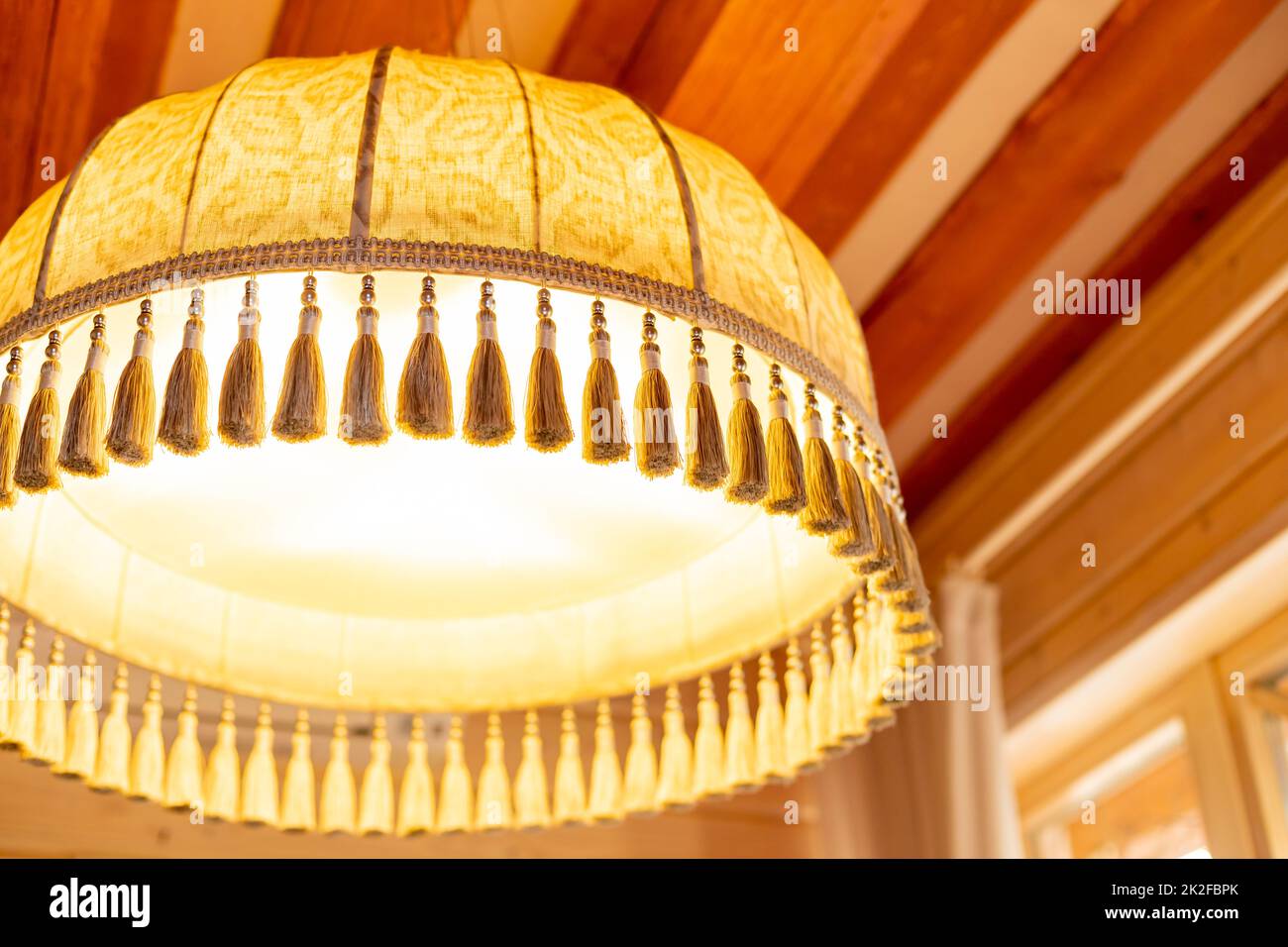 Large yellow fabric lampshade with fringe as an element of vintage ...