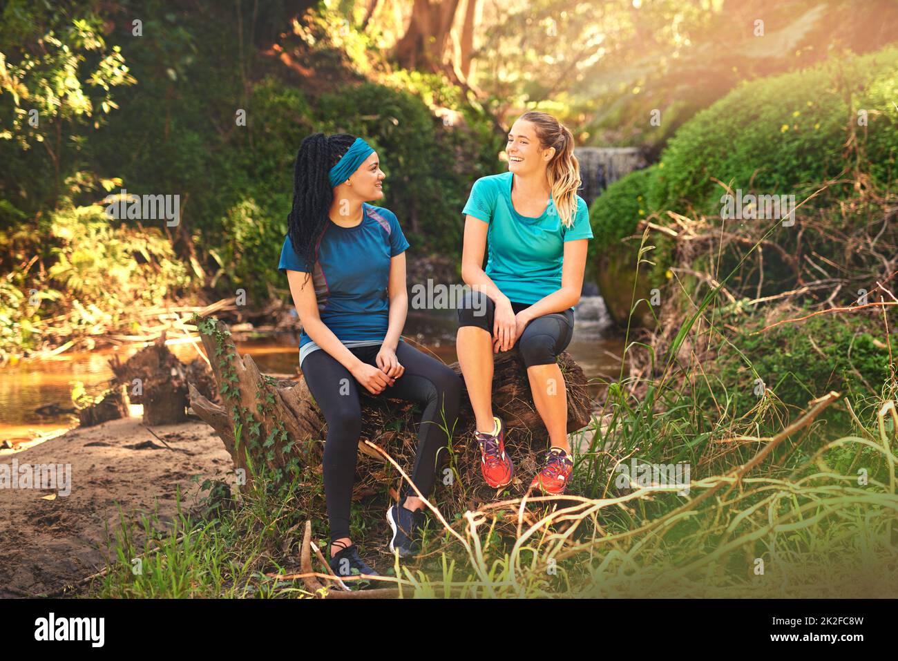Catching up while catching our breath. Shot of two sporty young women ...