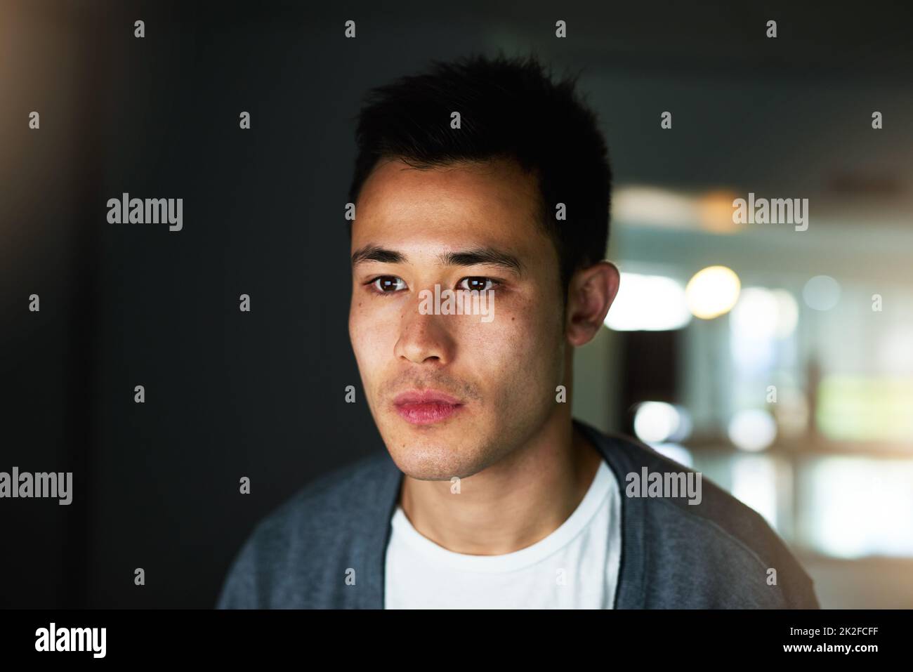 Long hours are sometimes required. Shot of a handsome young male ...