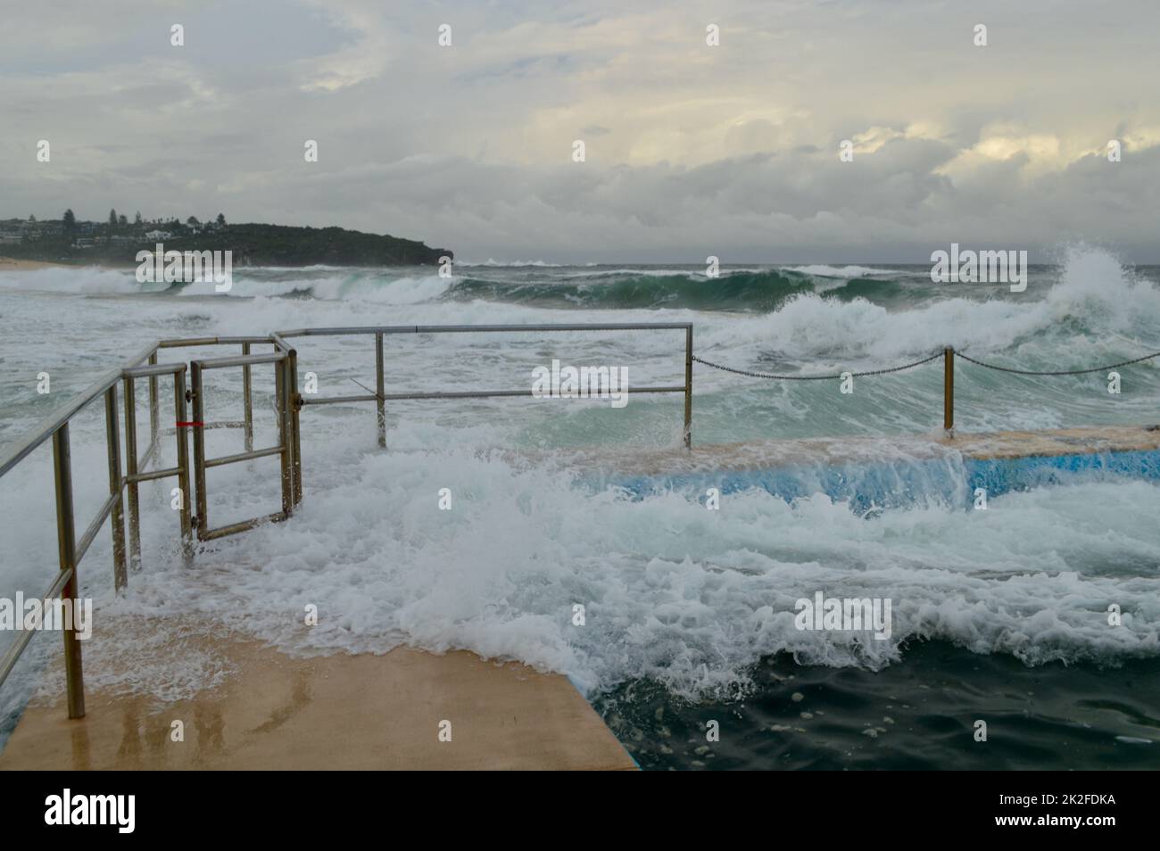 Waves break onto the rock pool at South Curl Curl Beach in Sydney ...