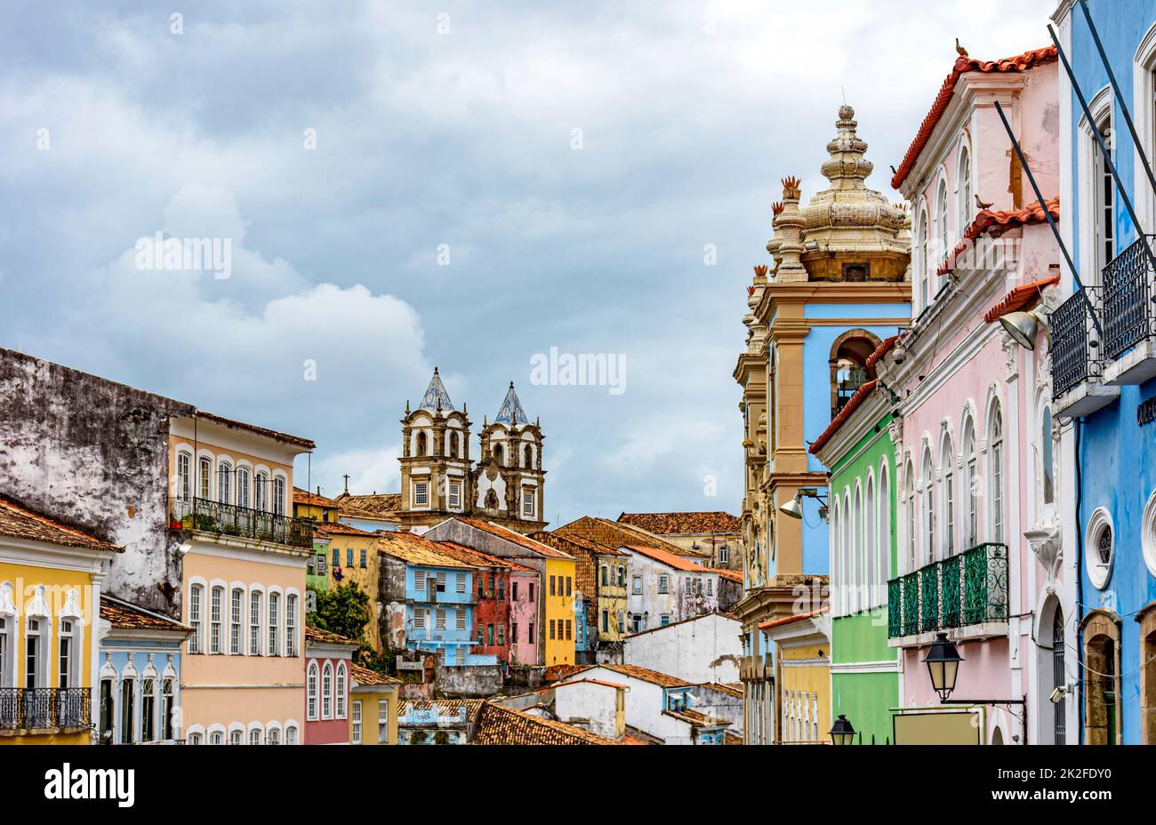 Colorful historical colonial houses facades and church towers in ...
