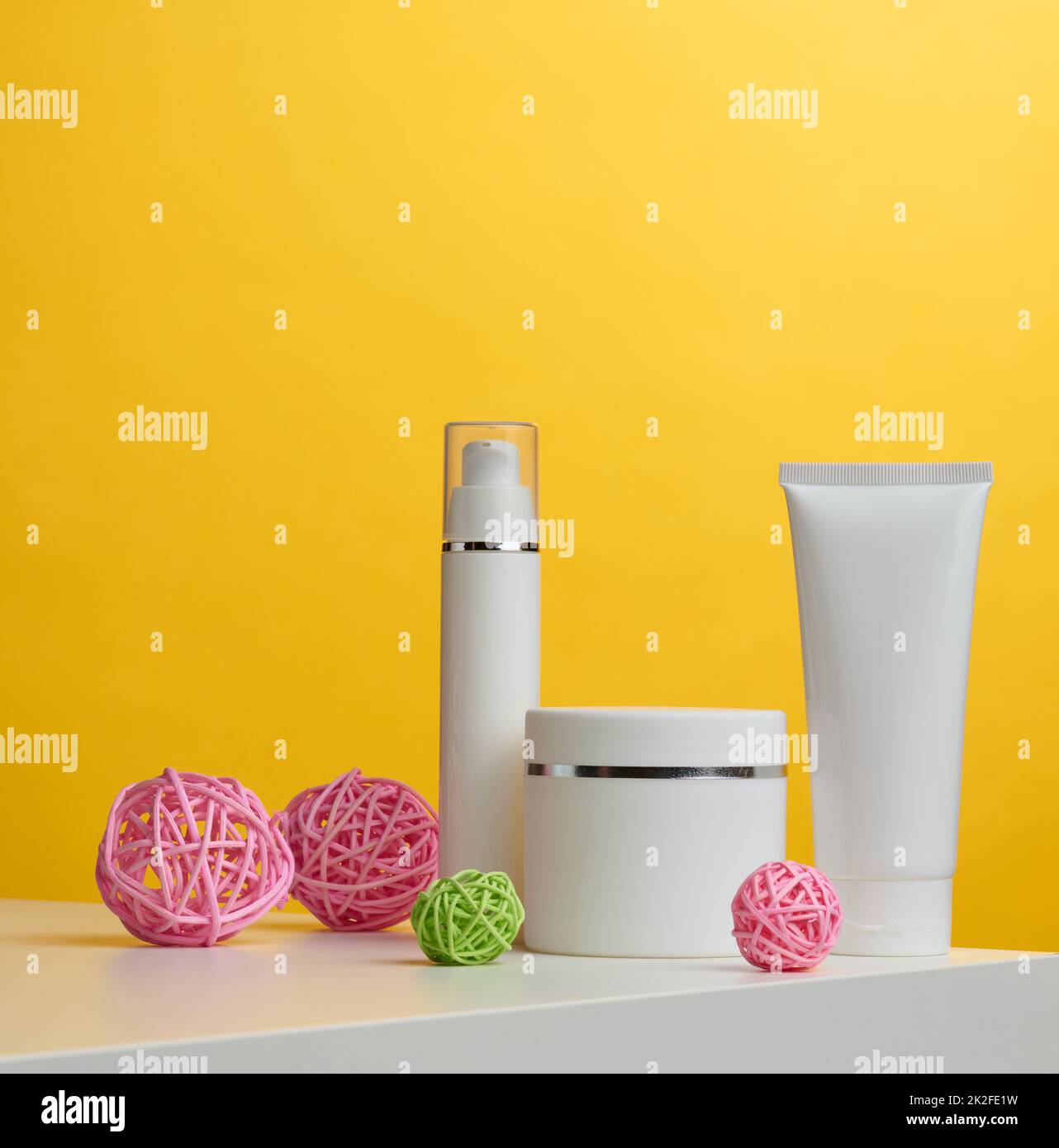 Empty white plastic tubes and jars for cosmetics. Packaging for cream ...