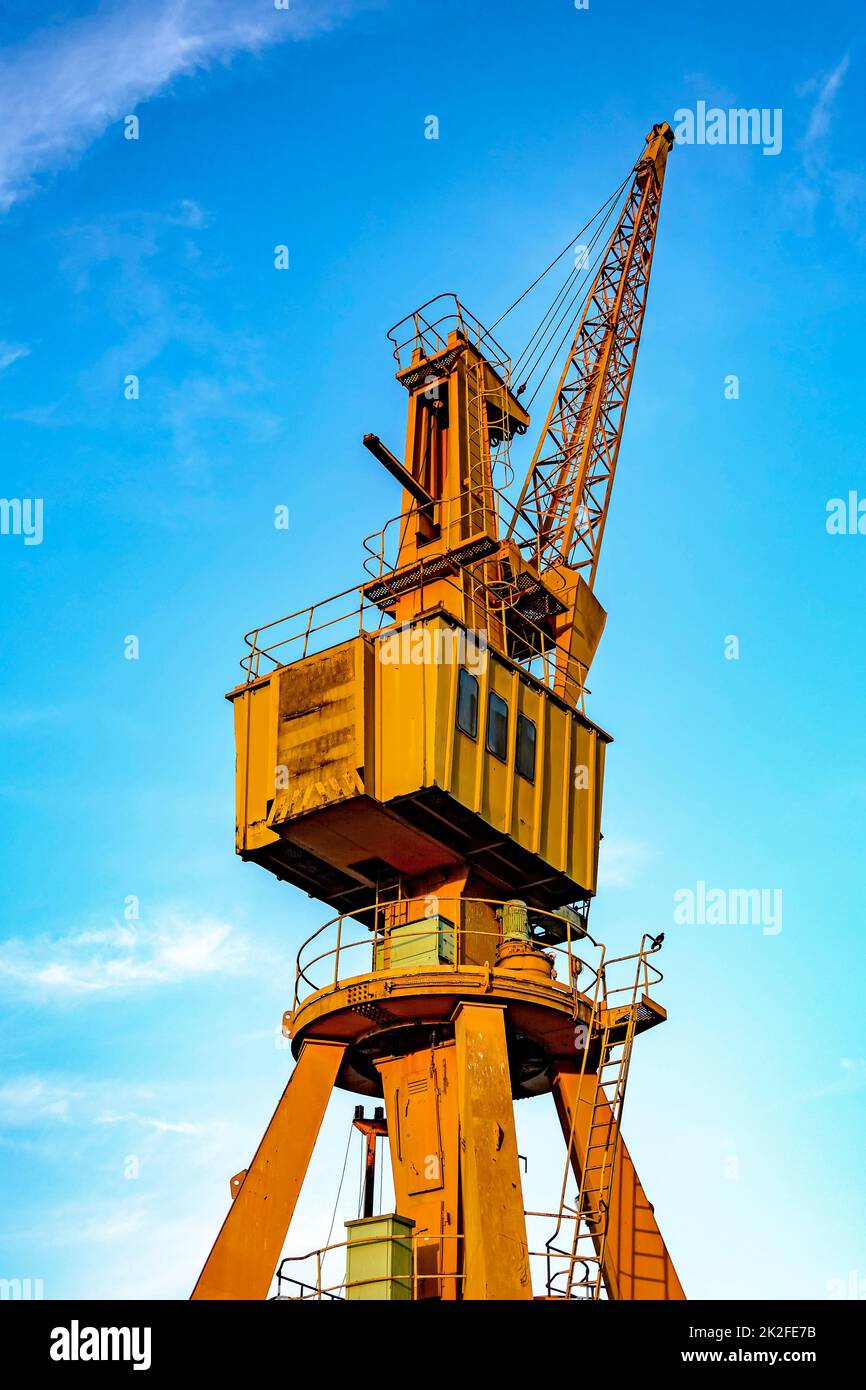 Old and obsolete yellow crane Stock Photo - Alamy