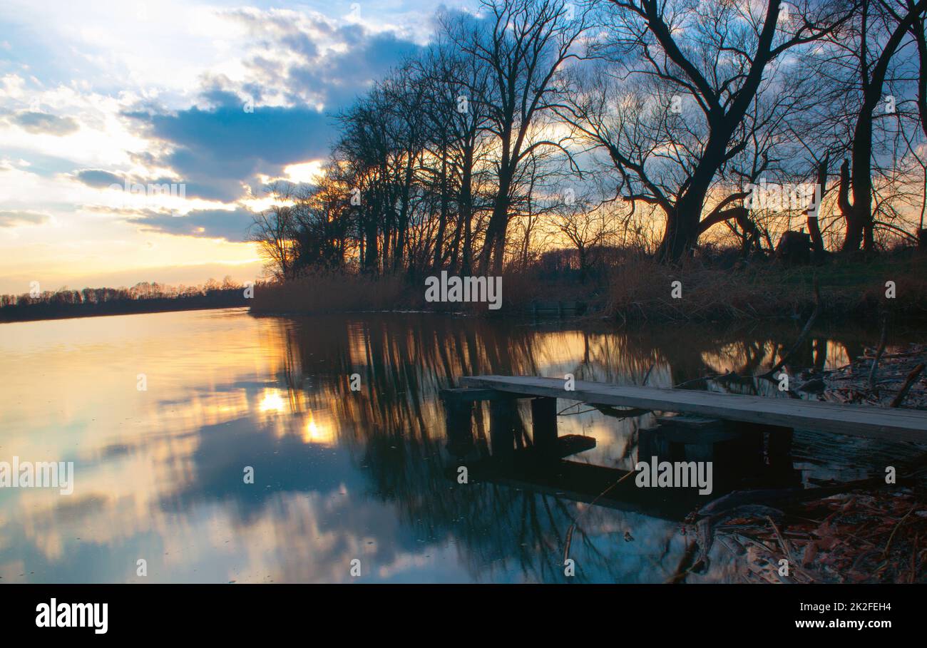 Springboard on shore of lake in the setting sun 3 Stock Photo - Alamy