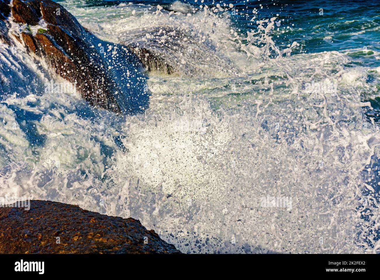 Waves crashing against rocks with water Stock Photo - Alamy