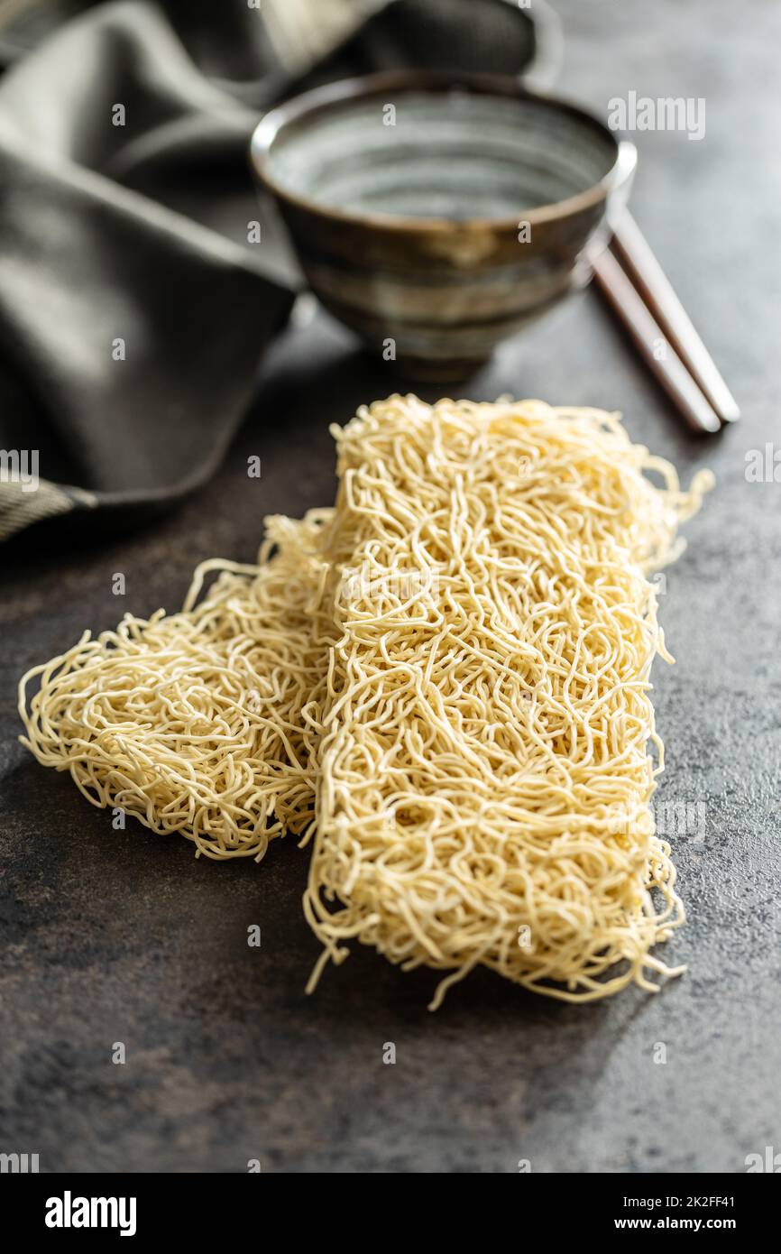 Instant noodles. Uncooked chinese noodles on black kitchen table Stock ...