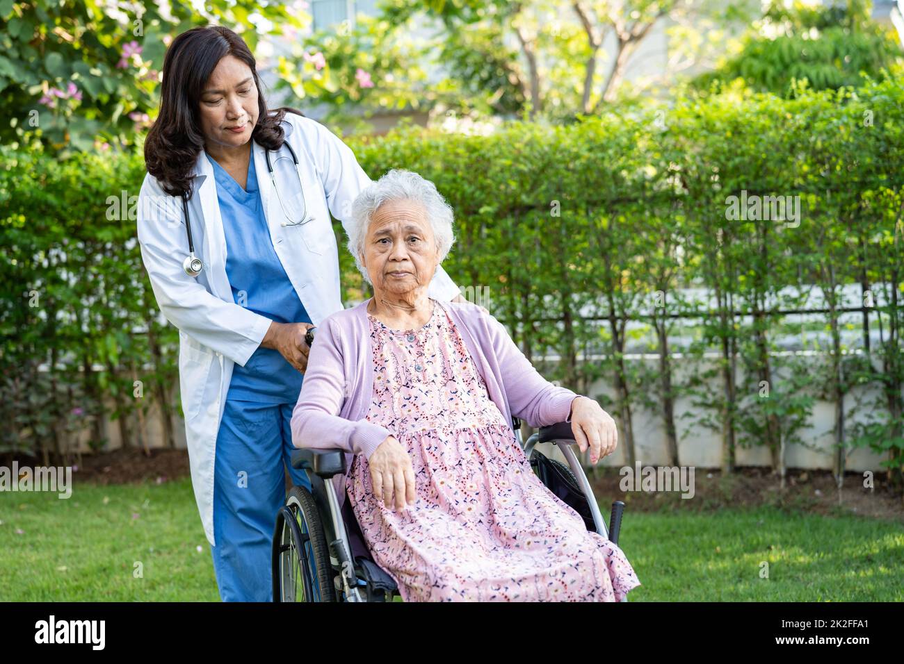 Doctor help and care Asian senior or elderly old lady woman patient sitting on wheelchair at ...