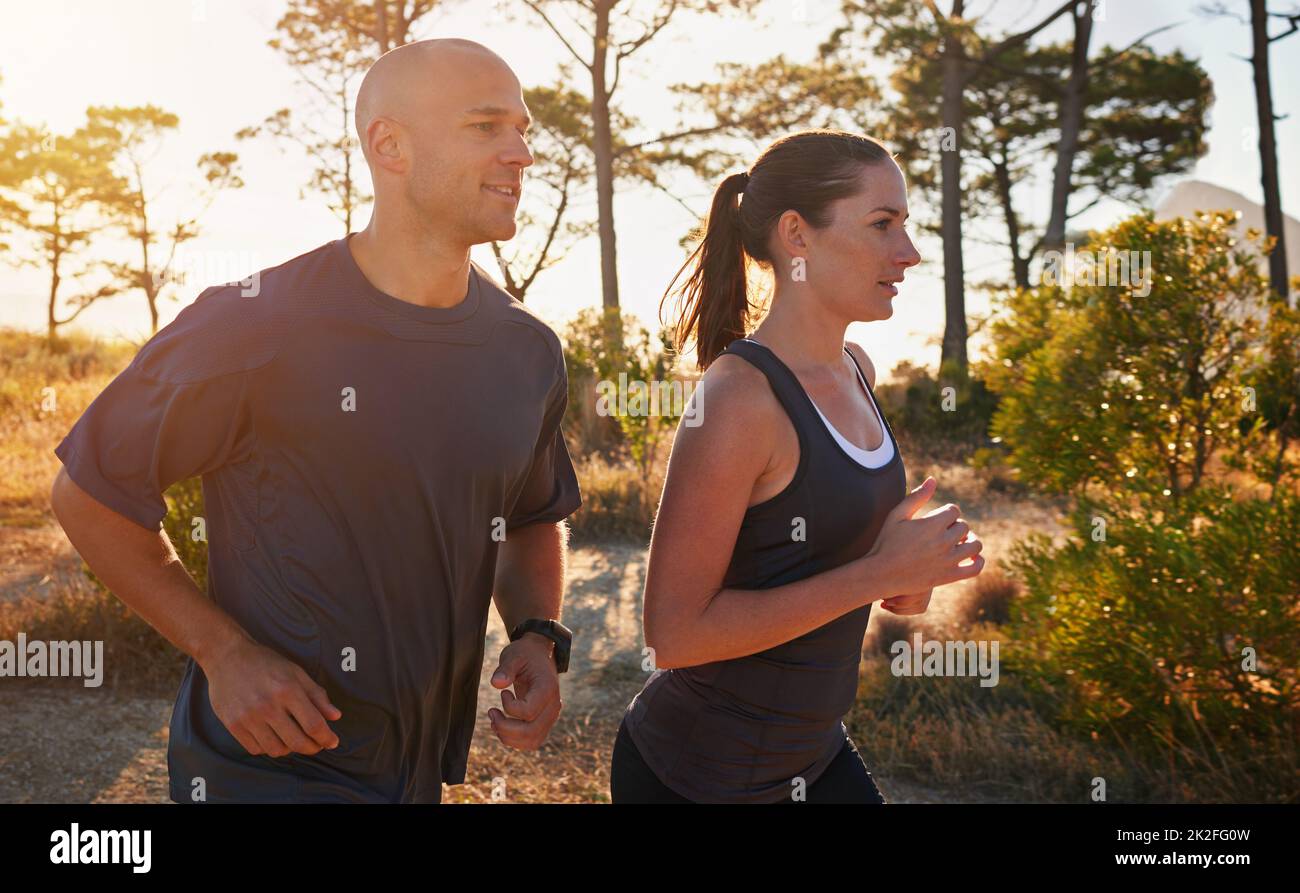 Running off the beaten path. a young couple doing a trail run together ...