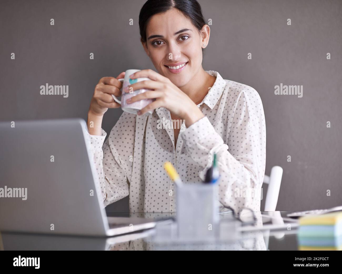 Taking a little break. Portrait of a beautiful young woman working on ...