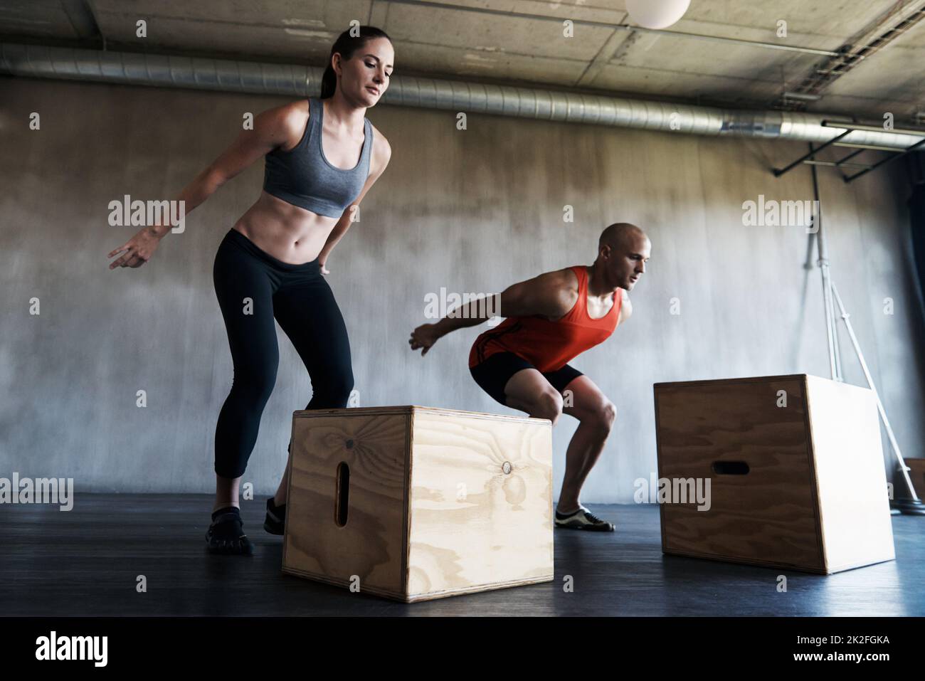 Reach your beast mode. a man and woman training together at the gym ...