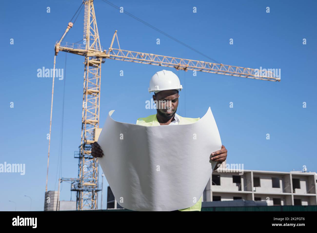 African American architect compares building to drawings Stock Photo ...