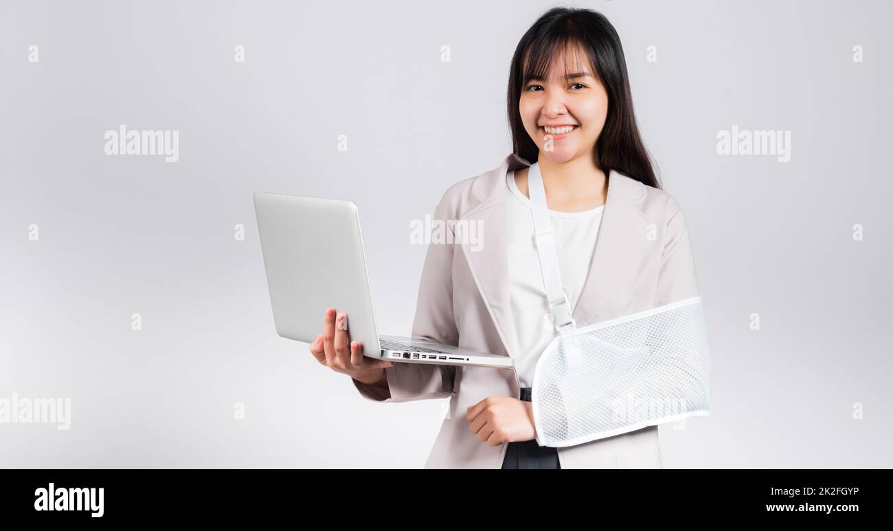 Asian business woman confident smiling broken arm after accident and ...