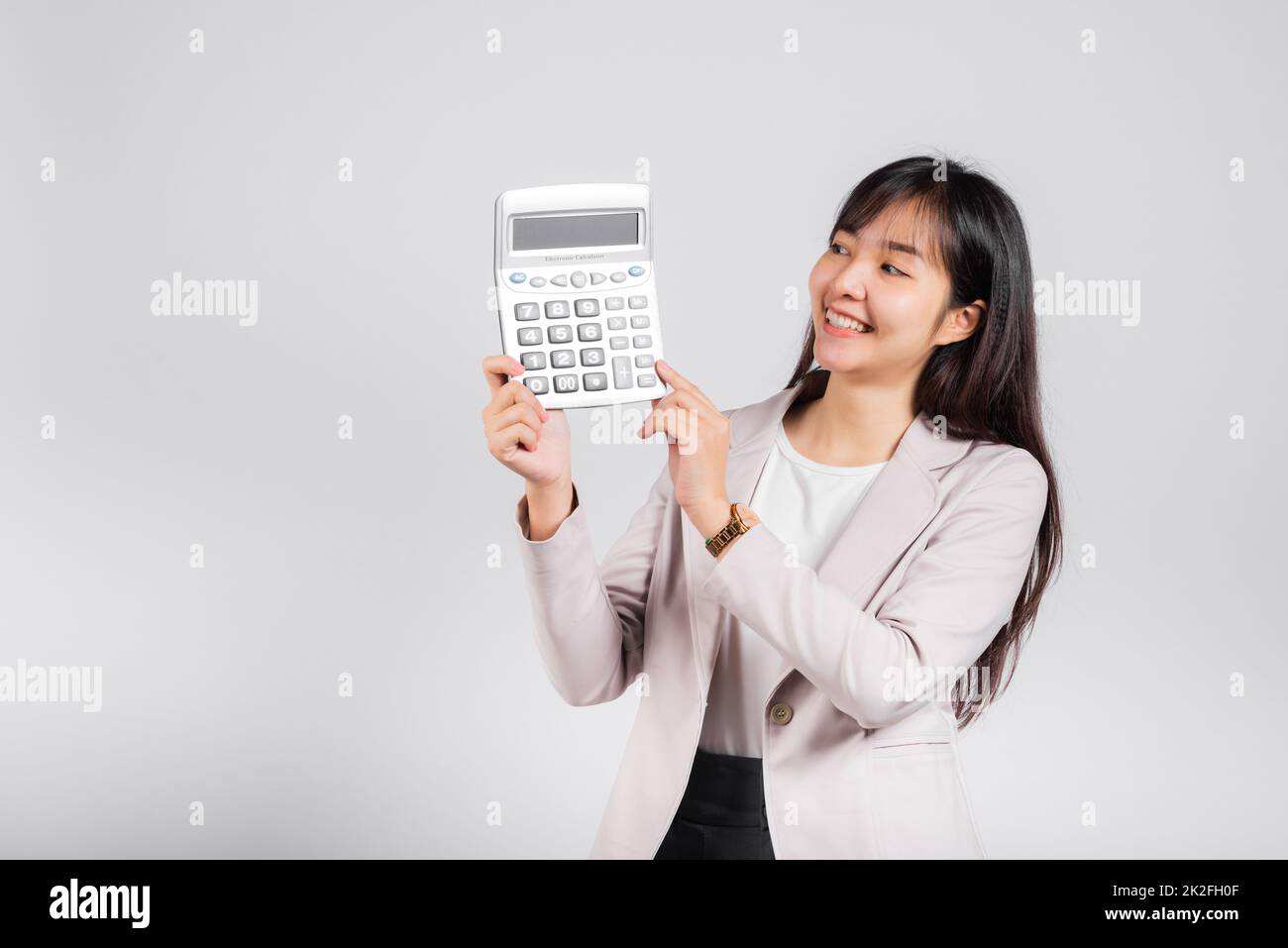 Woman confident smiling holding electronic calculator Stock Photo - Alamy