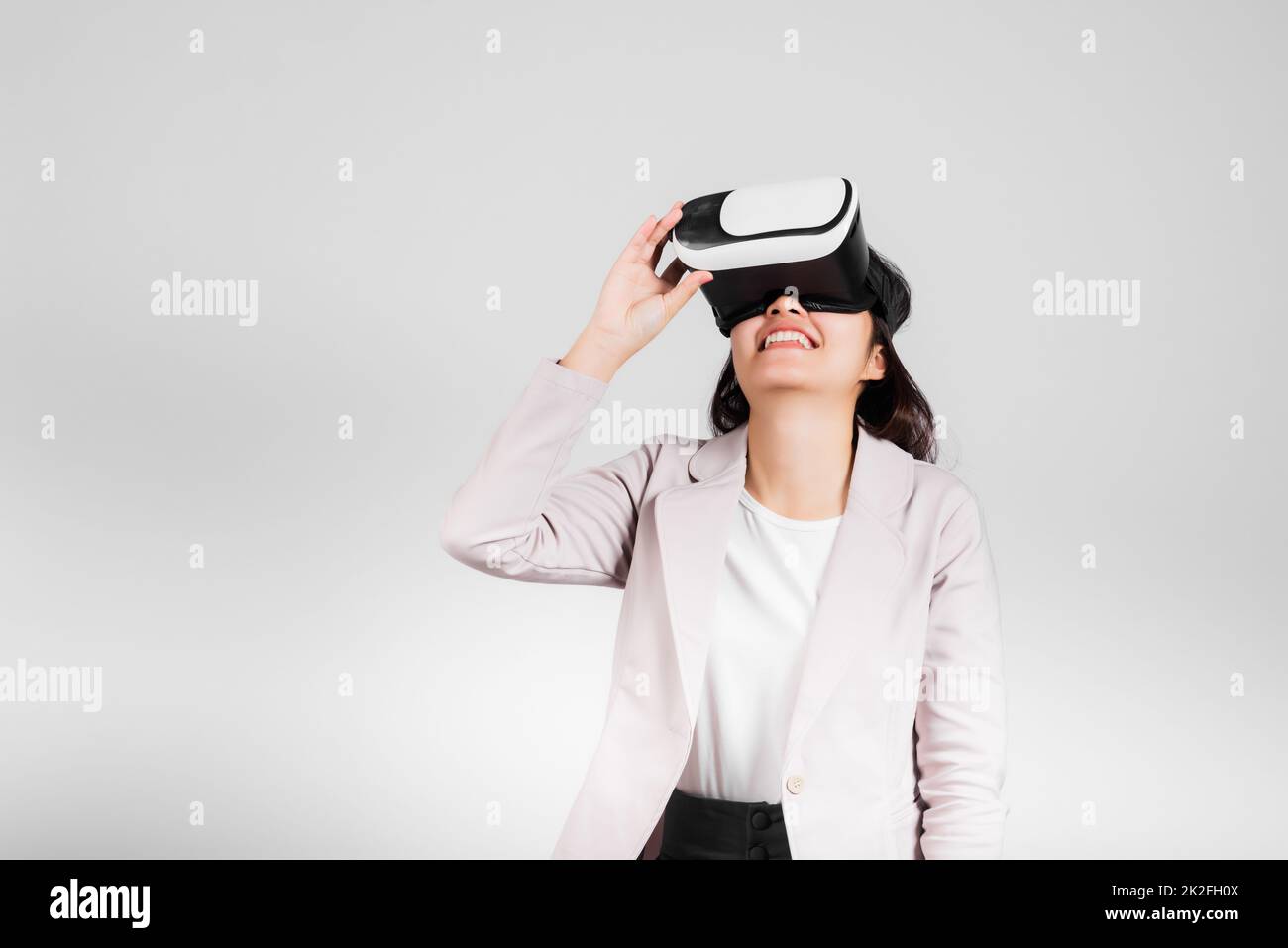 Smiling woman confidence excited wear VR headset device during virtual ...