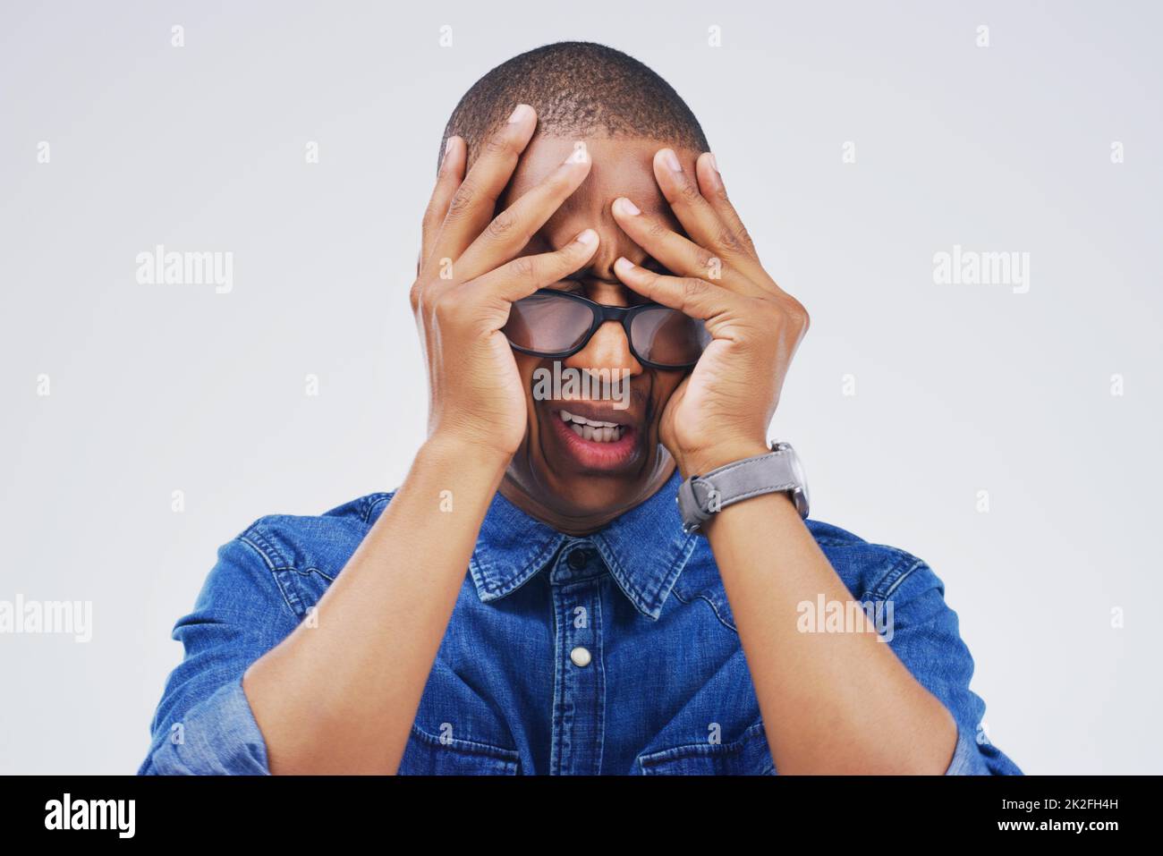 The pressure is mounting. Studio shot of a handsome young man looking ...
