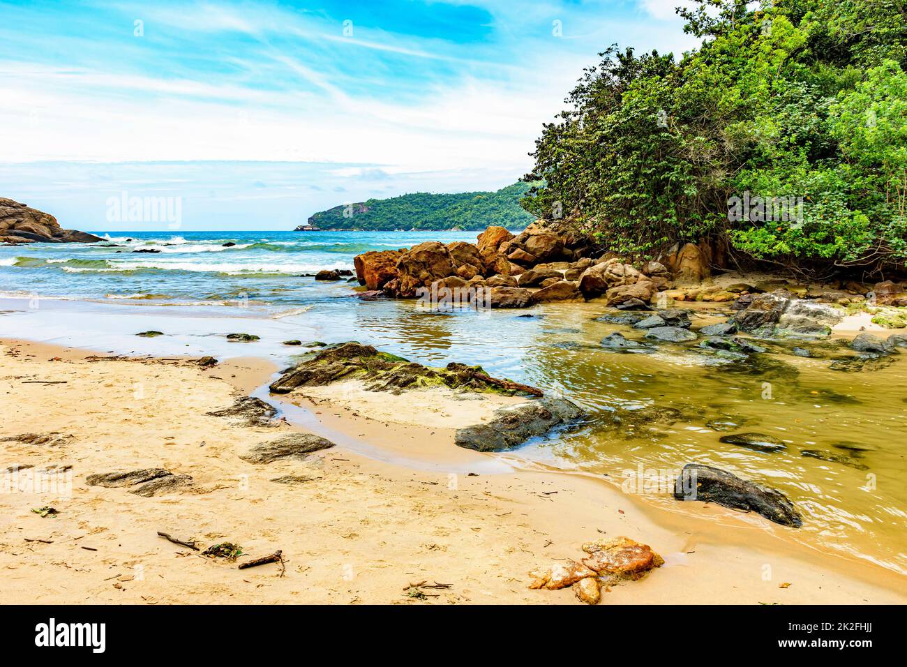 River flowing into the beach between the sea, the rocks and the ...
