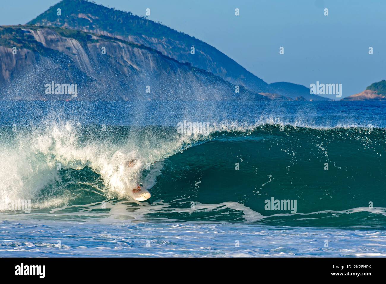 Surfer inside the tube in a wave Stock Photo - Alamy