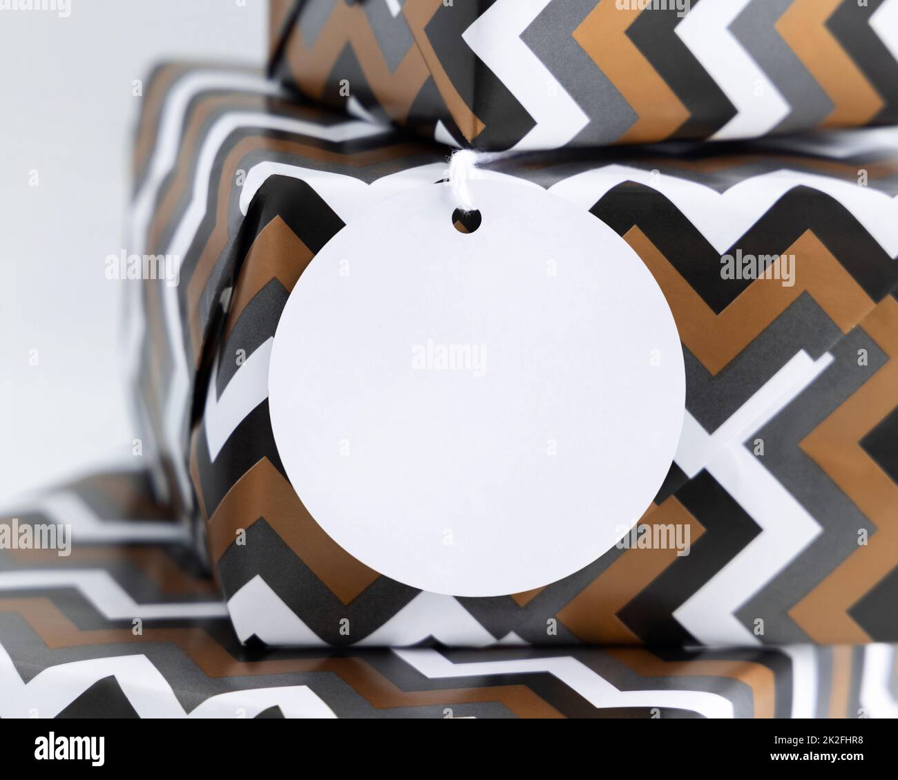 Presents Wrapped in chevron paper with blank gift tag close up, label ...