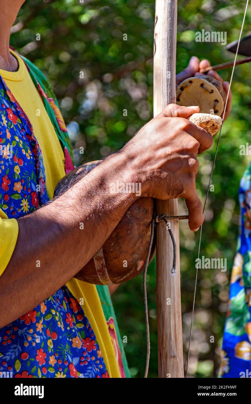 Berimbau player playing his instrument Stock Photo - Alamy