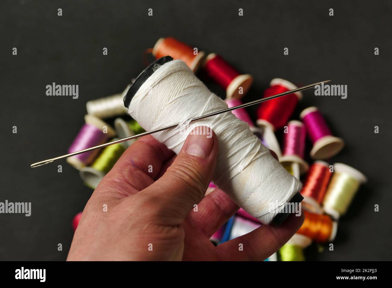 close-up there are lots of colorful spools of thread, thick sewing ...