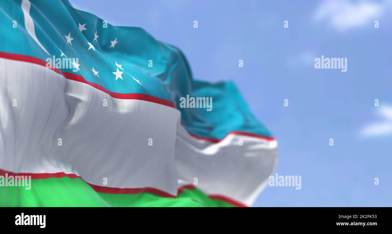 Detail of the national flag of Uzbekistan waving in the wind on a clear ...