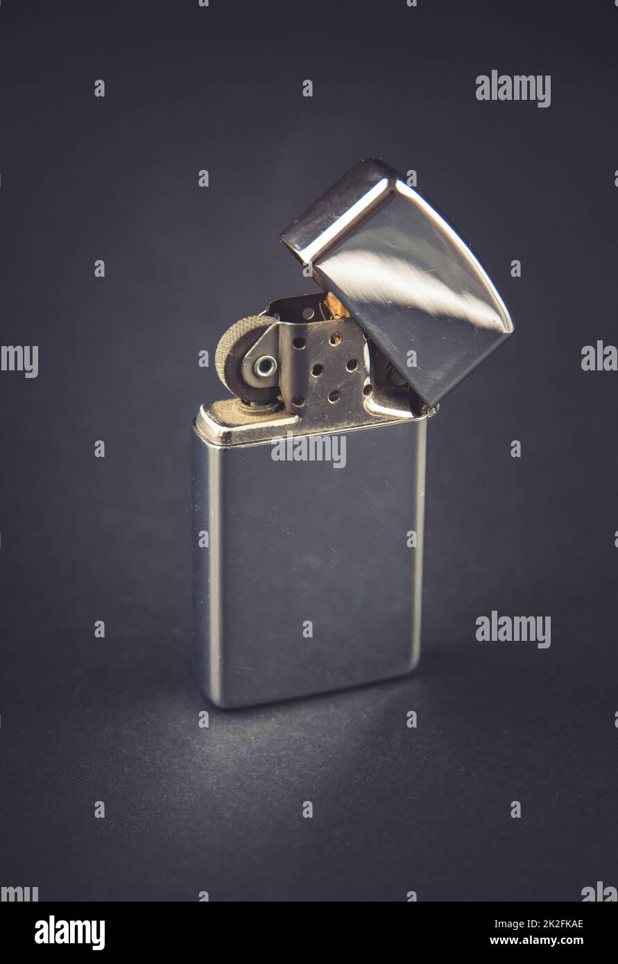 Old vintage lighter on a dark background Stock Photo - Alamy