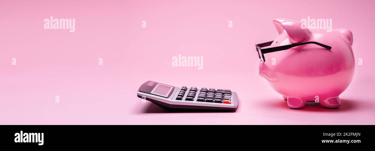Pink piggy bank calculator hi-res stock photography and images - Alamy