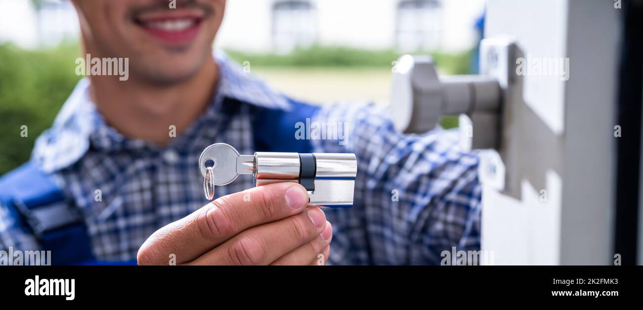 Locksmith Lock Door Repair. Worker Changing Stock Photo - Alamy
