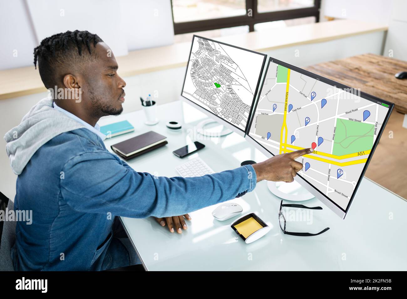 Businessperson Analyzing Cadastre Map On Computer Stock Photo - Alamy