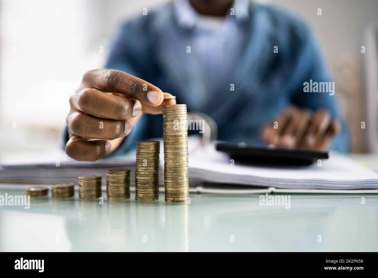 African Accountant Using Calculator. Tax Money Stock Photo - Alamy