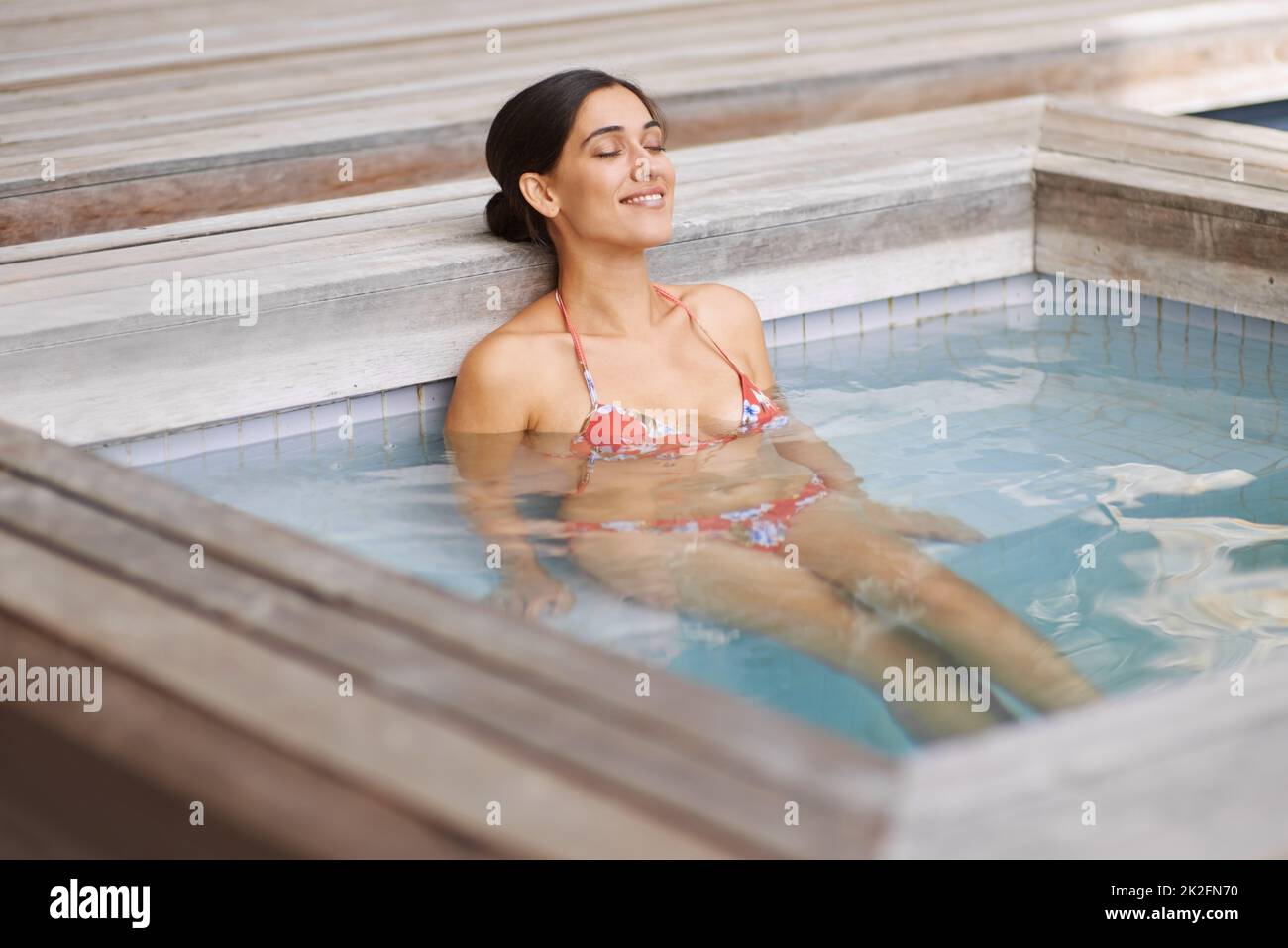 Enjoying a little R and R. an attractive young woman relaxing in a jacuzzi Stock Photo - Alamy