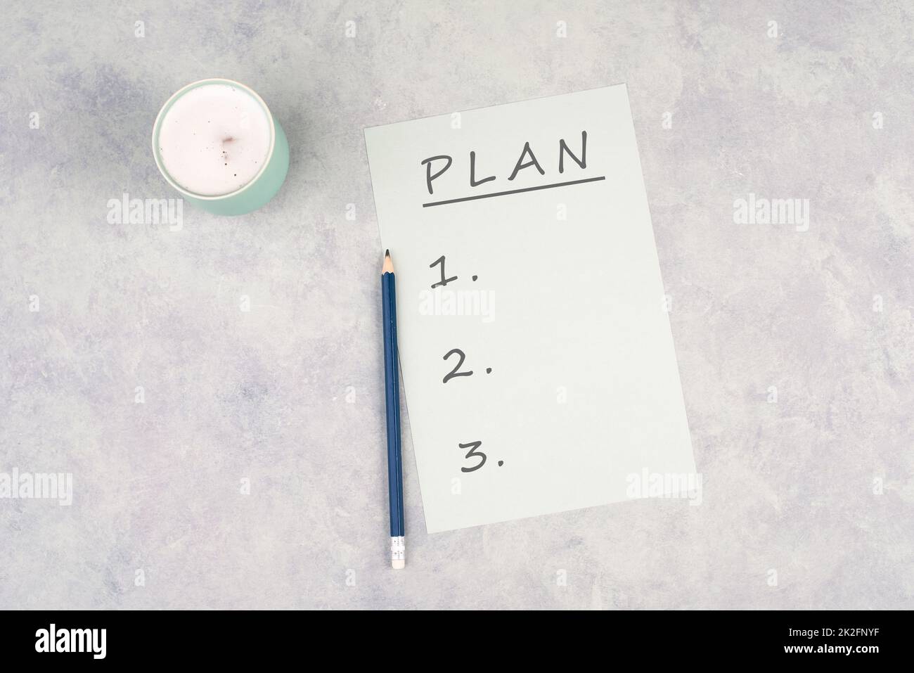 Empty paper with a pen on a textured background, the word plan is ...