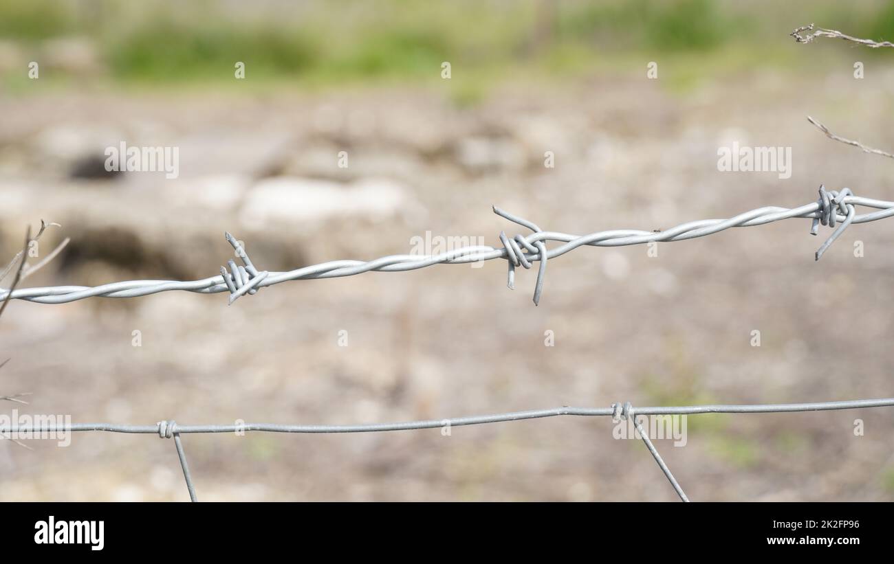 Barbed wire. Part of guarding farm fence. A close up of a barbed wire ...