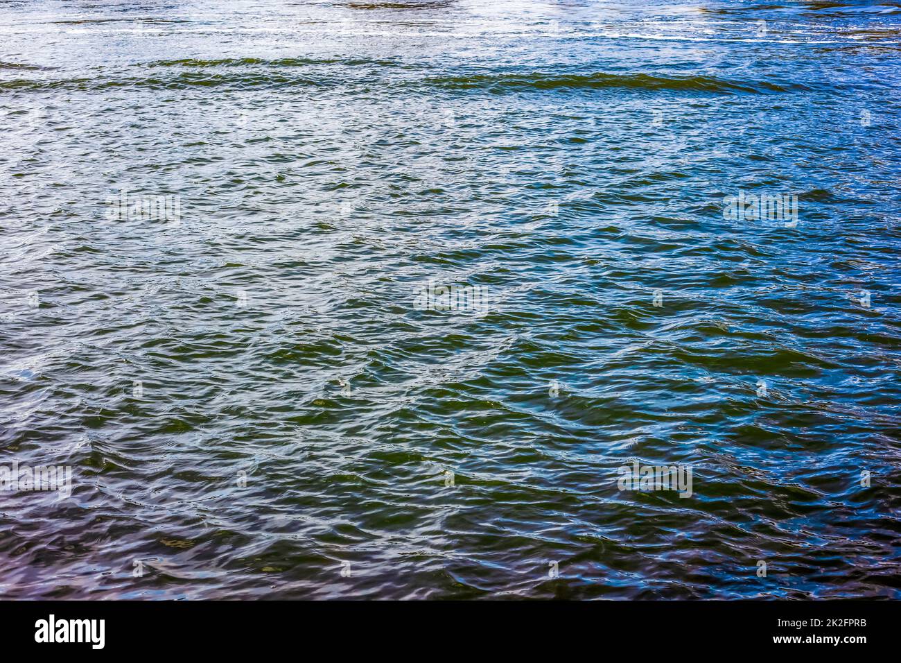 Water surface with waves and ripples and the sunlight reflecting Stock ...