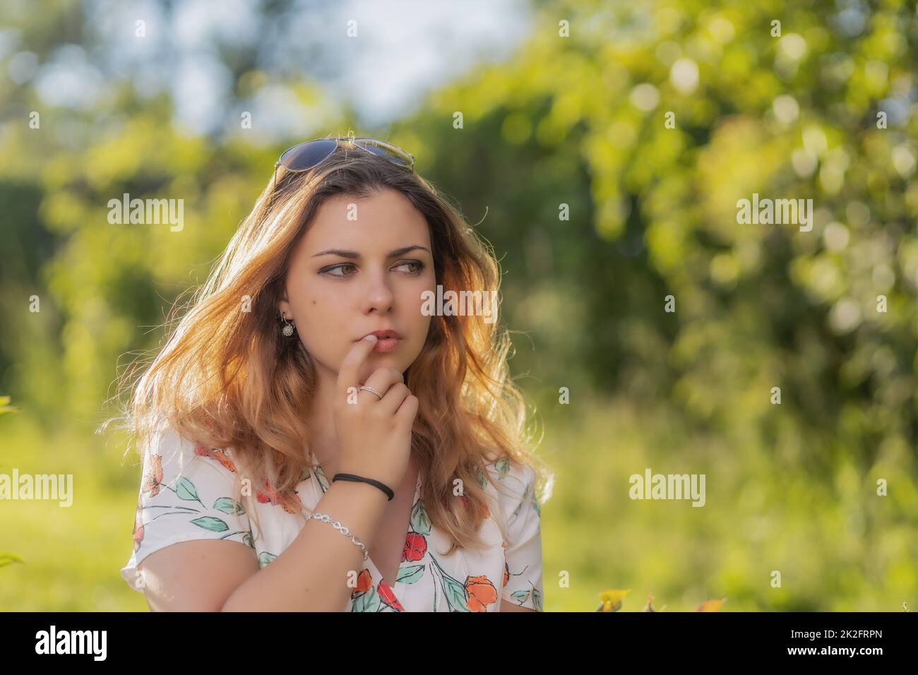 Thoughtful atractive l young woman is posing outdoors Stock Photo - Alamy