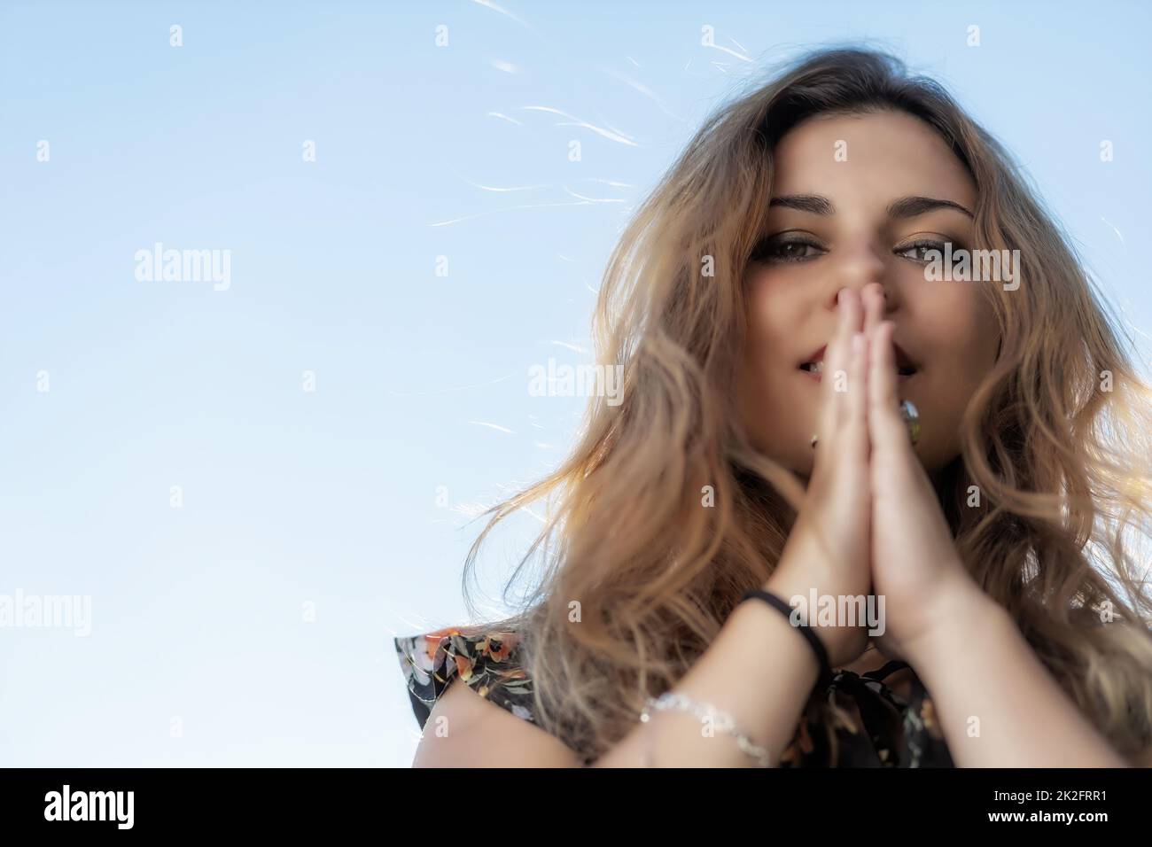 Atractive beautiful young woman is posing against blue sky Stock Photo ...