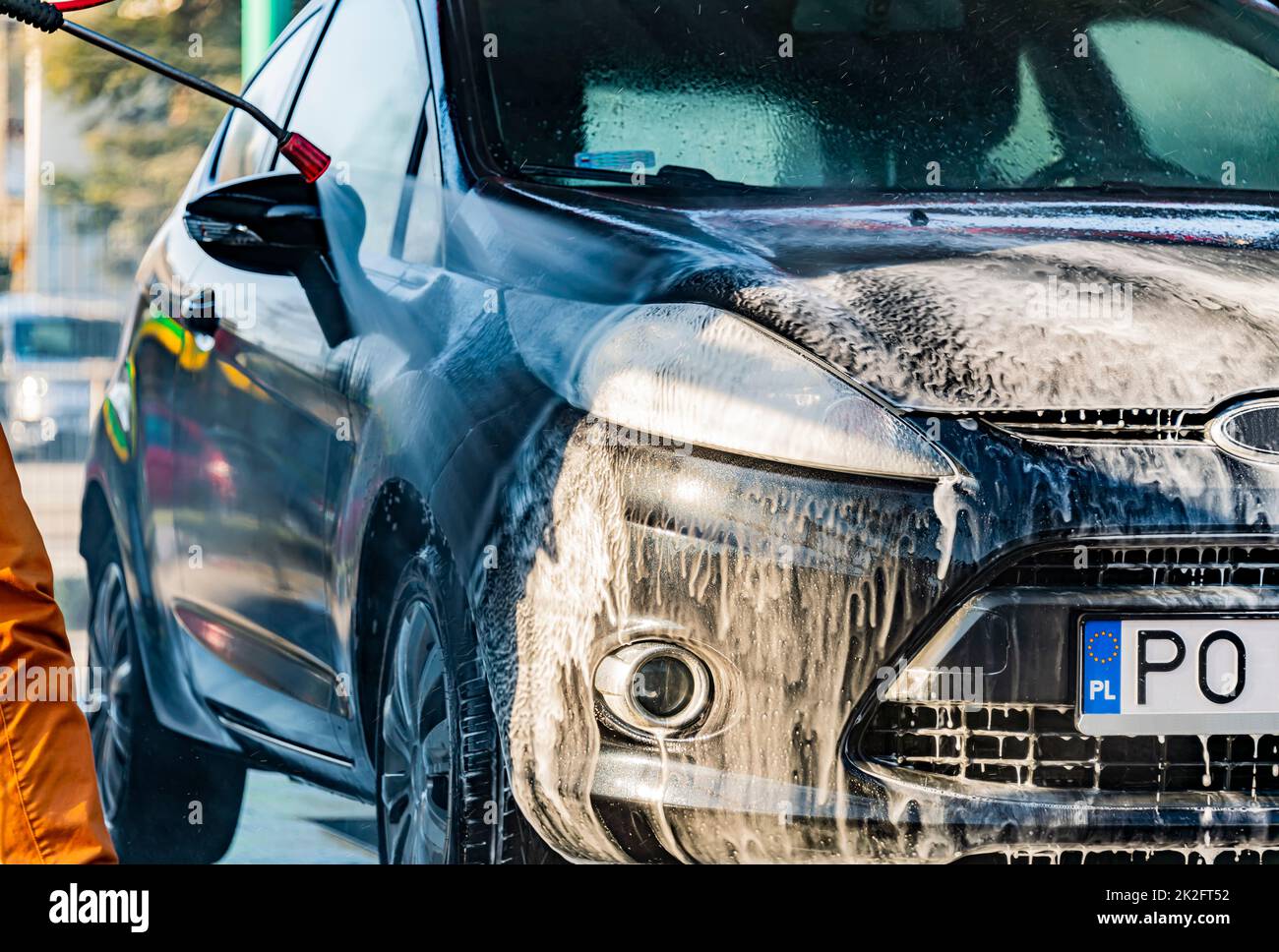 A vehicle in a coin-operated self-service car wash Stock Photo - Alamy