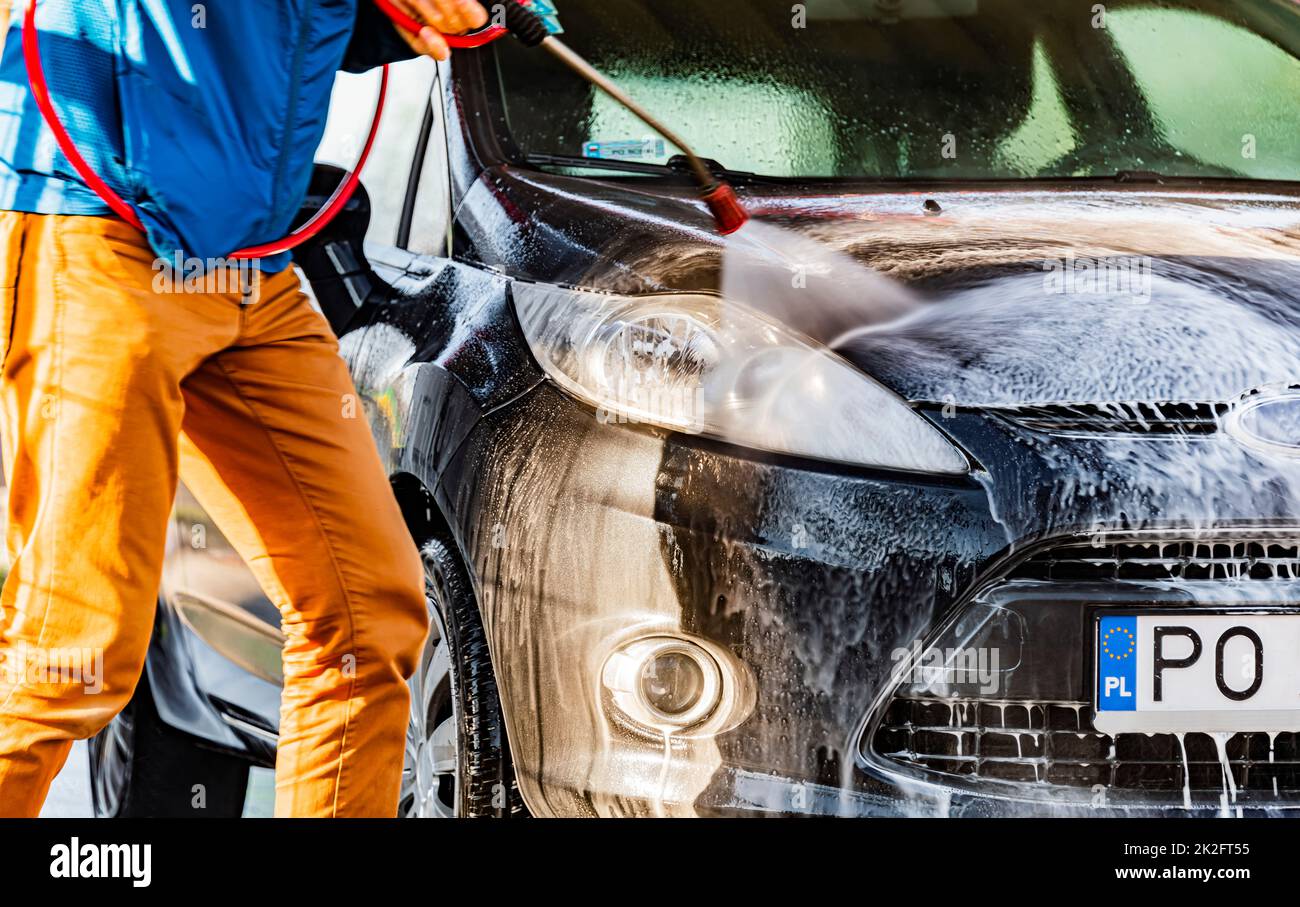 A vehicle in a coin-operated self-service car wash Stock Photo - Alamy