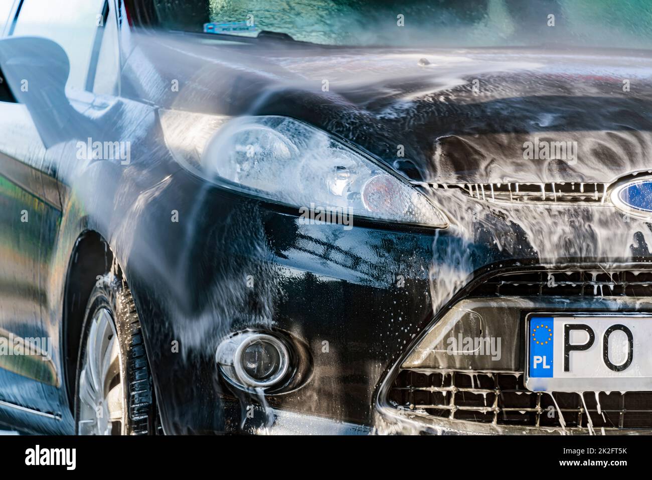 A vehicle in a coin-operated self-service car wash Stock Photo - Alamy
