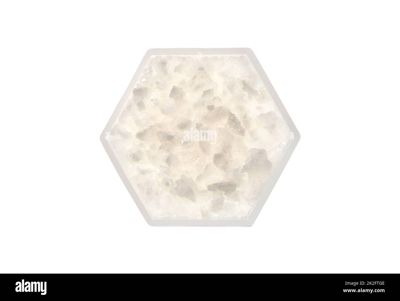 Flake salt in hexagonal molecular shaped container on white background ...